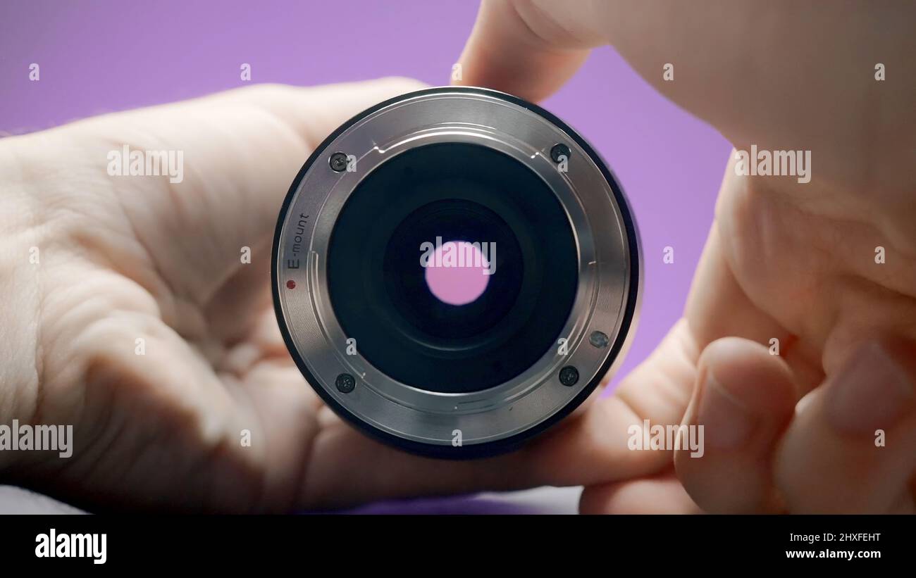 Close-up of man rotating lens. Action. Photographer turns ring of ...