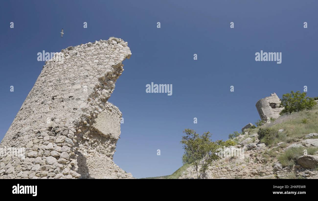 Ancient ruined castle on the top of the hill on blue clear sky ...