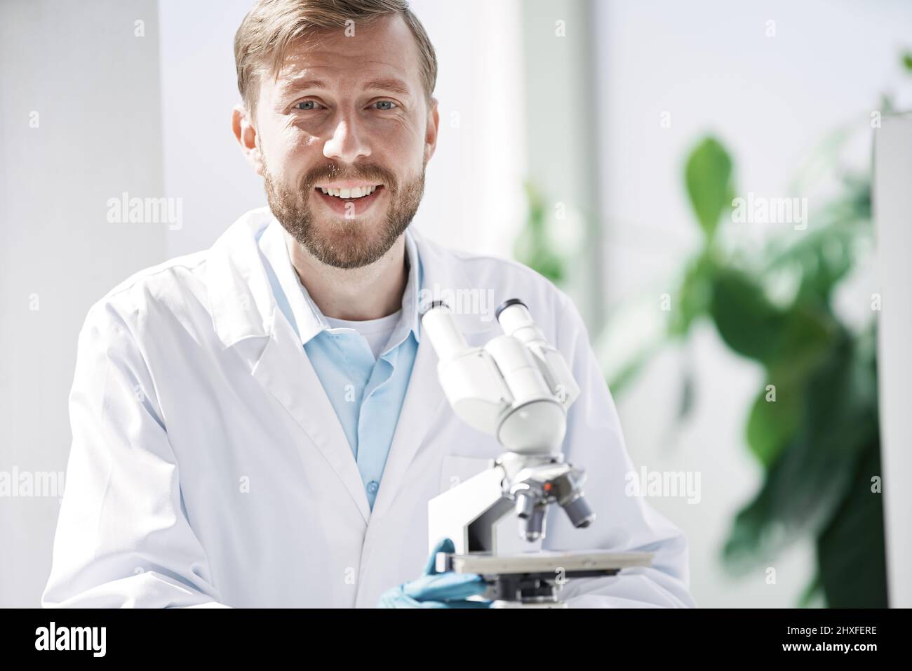 Sitting holding expertise examining science hi-res stock photography ...