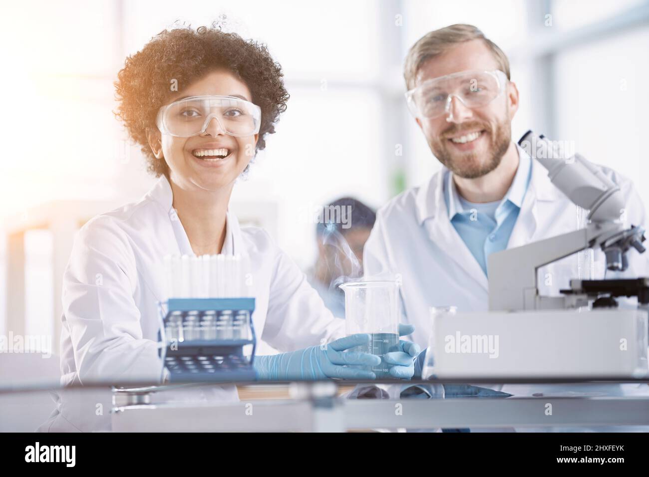 happy employees of the scientific laboratory sitting at the laboratory ...