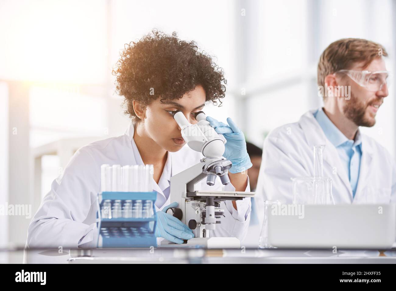 Female chemist microscope table hi-res stock photography and images - Alamy