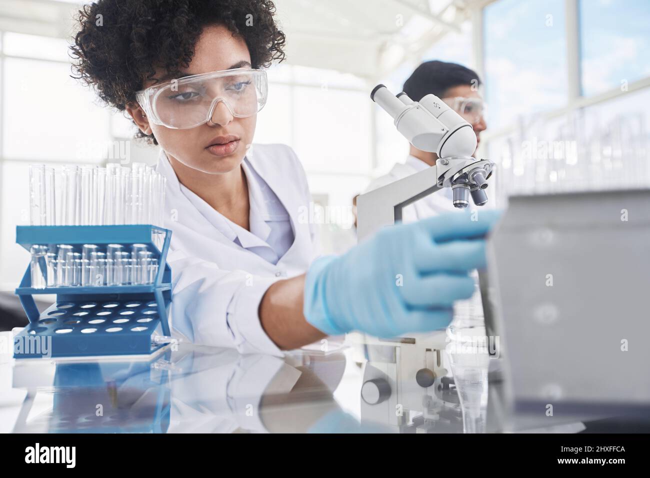 female scientist and her colleagues work in a medical laboratory Stock ...