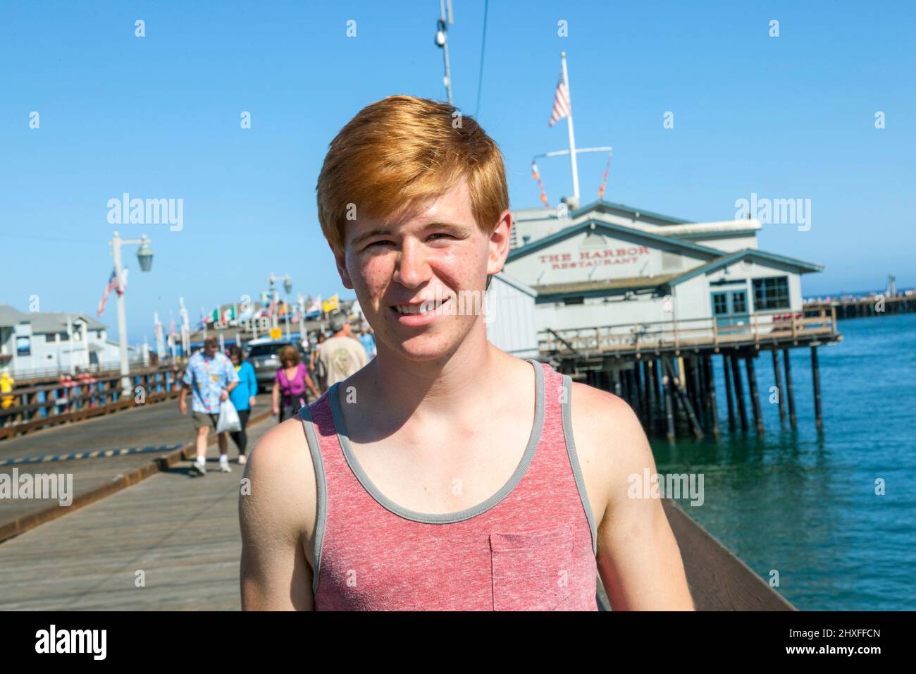 smiling attractive boy poses in front of the pier Stock Photo - Alamy