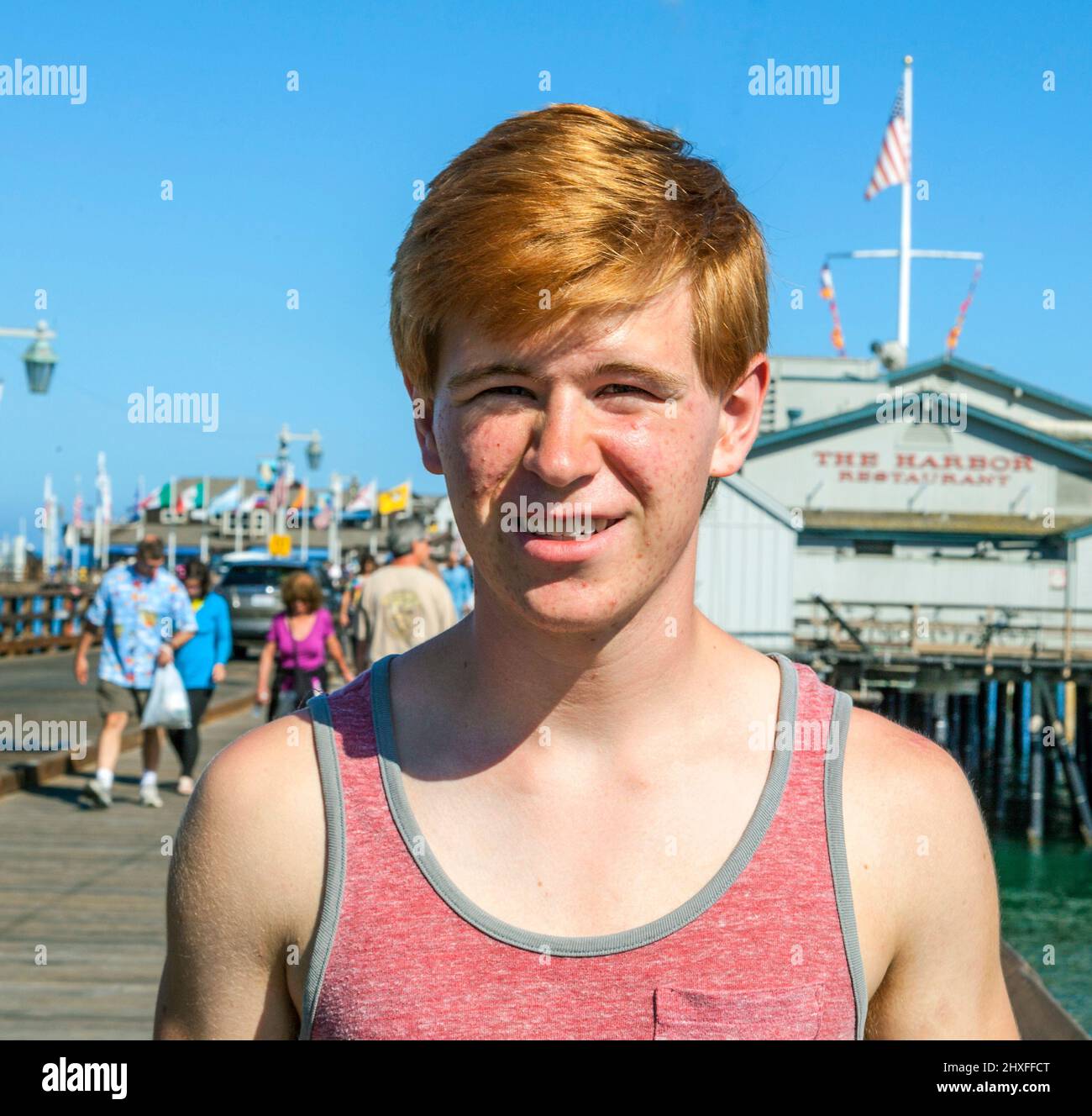 smiling attractive boy poses in front of the pier Stock Photo - Alamy