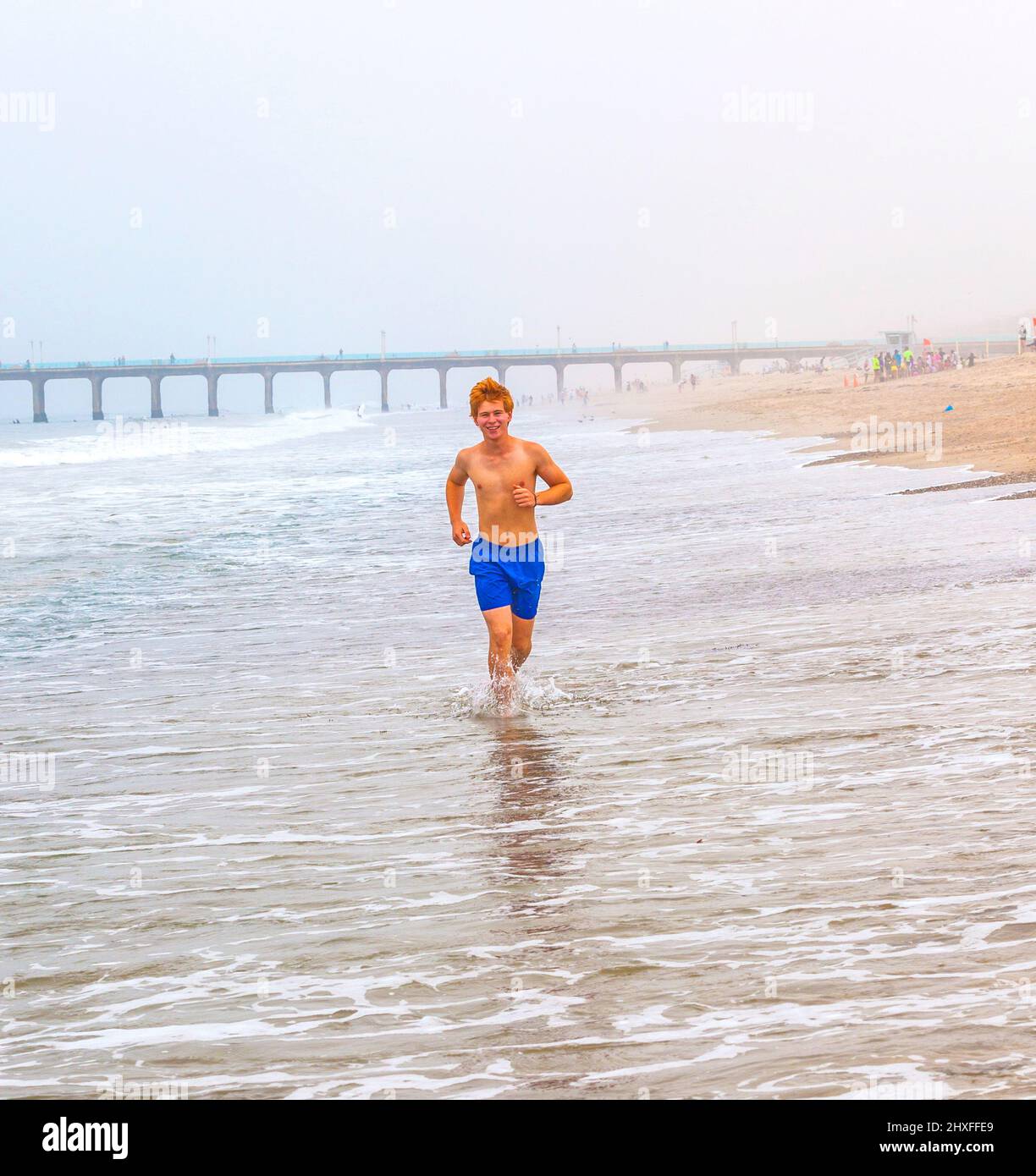 attractive young boy jogging at the beach Stock Photo - Alamy