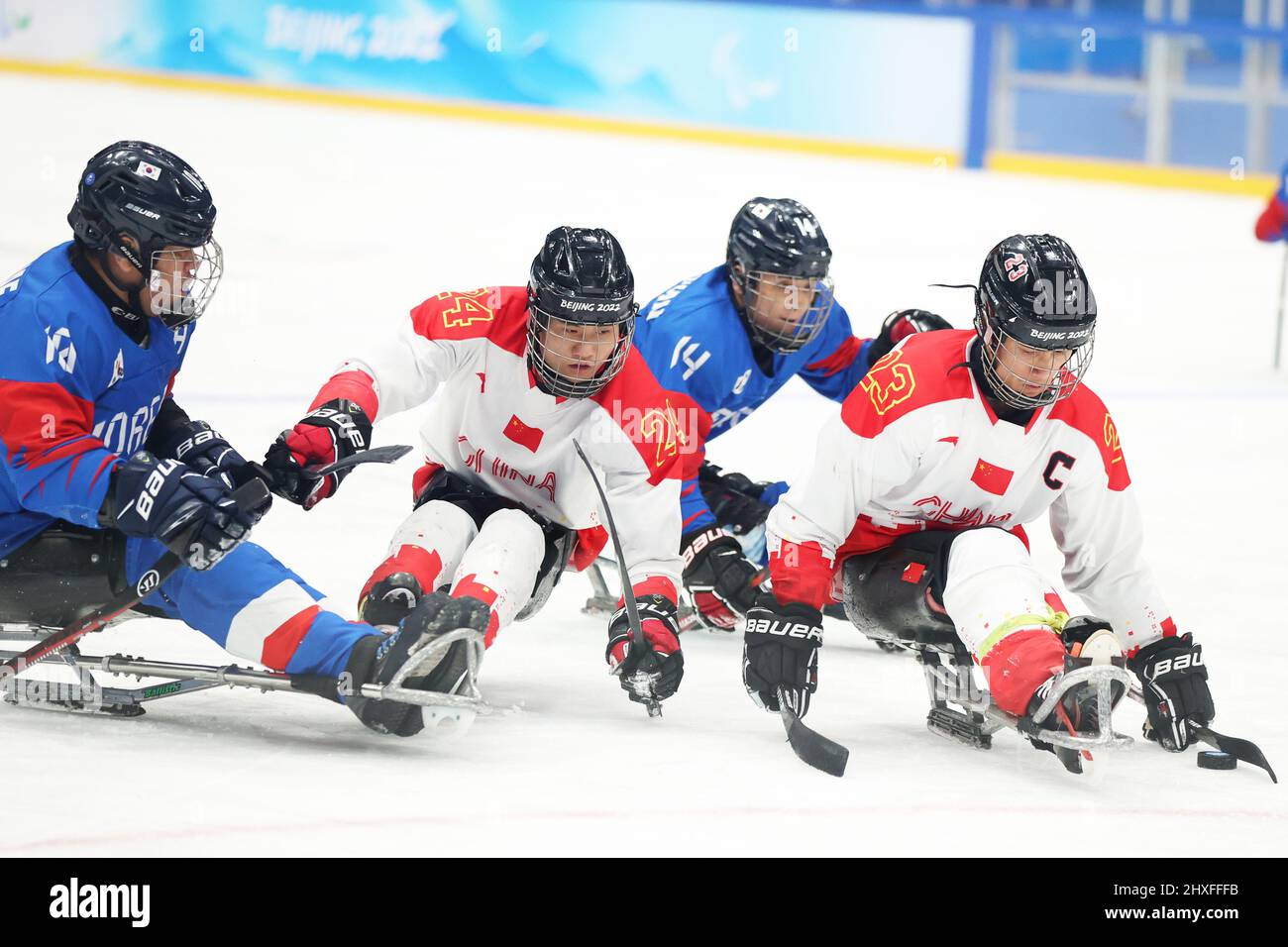 Beijing, China. 12th Mar, 2022. Cui Yutao (1st R) of China competes ...