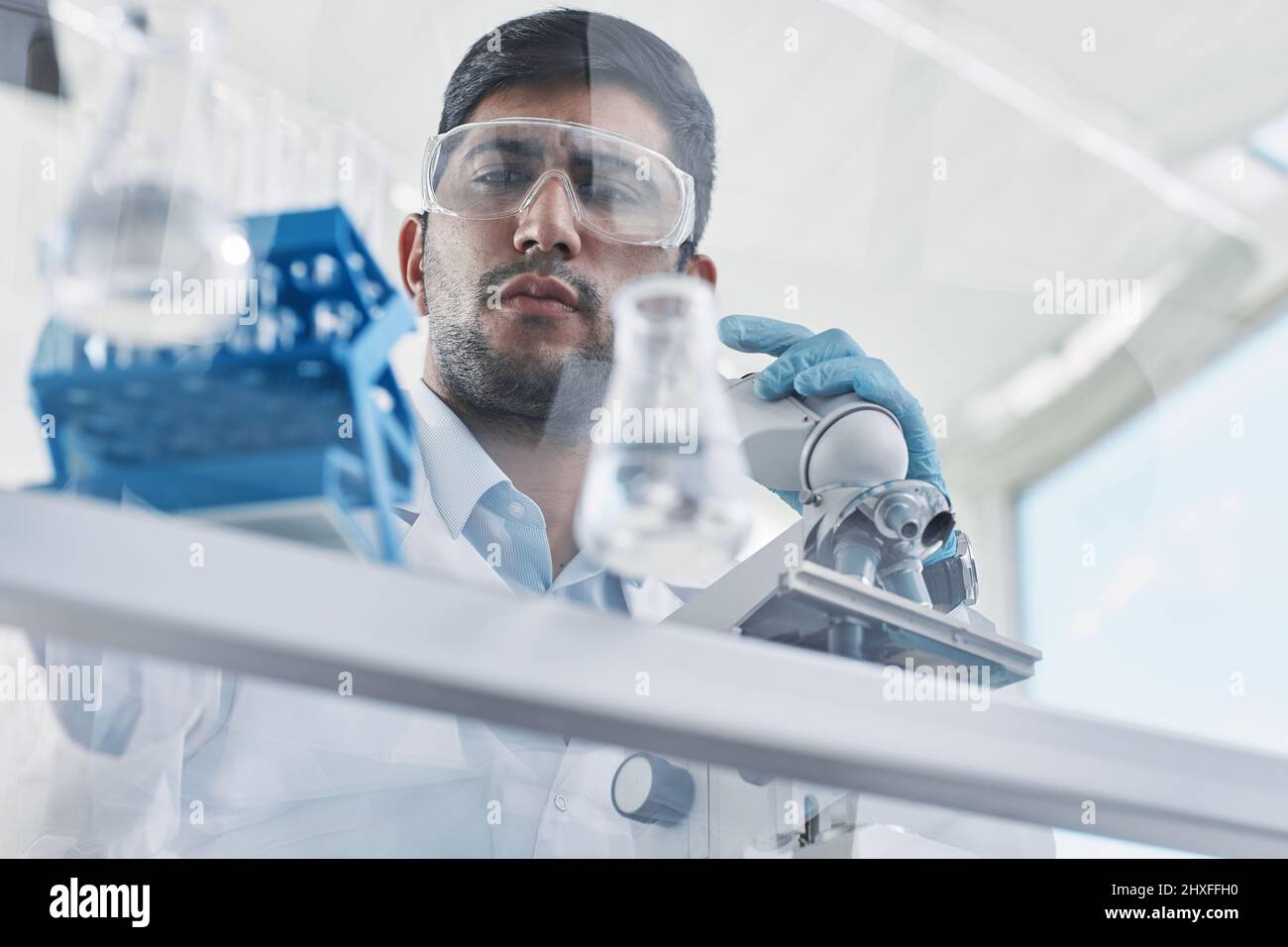 Scientist working microscope table hi-res stock photography and images ...