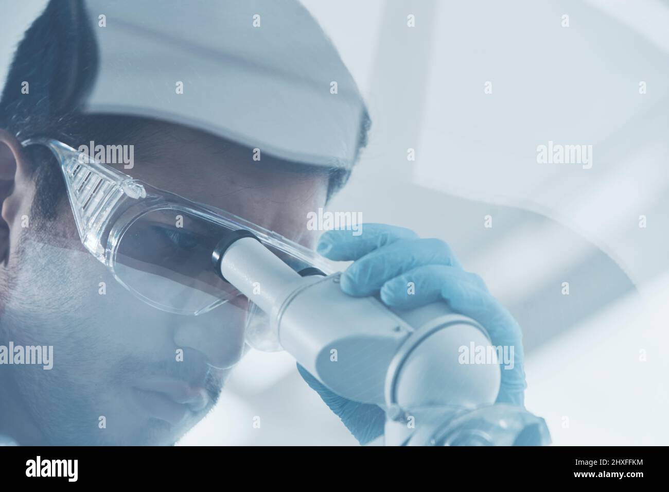 image of a scientist looking through a microscope Stock Photo - Alamy