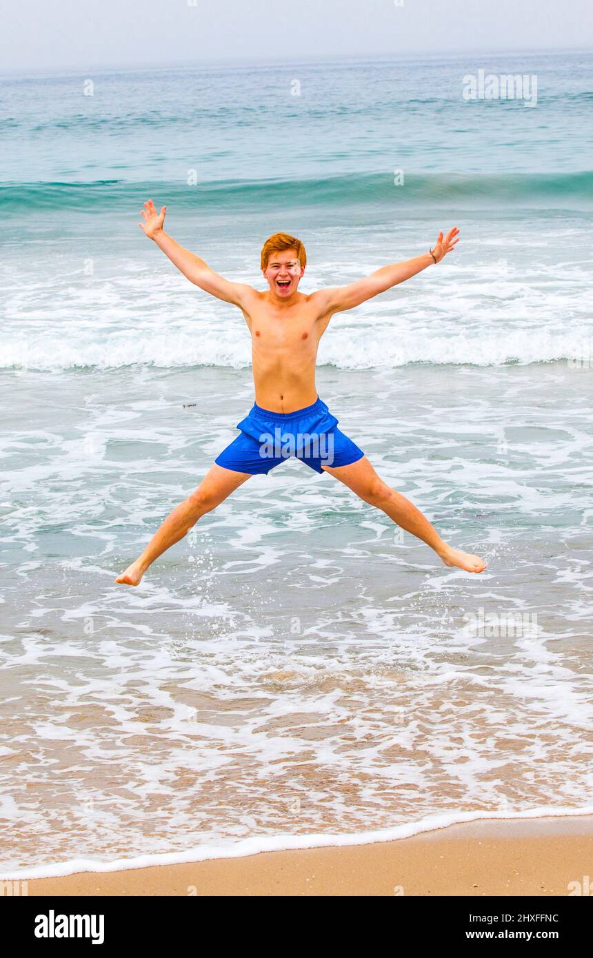 boy jumps in the air at the beach Stock Photo - Alamy