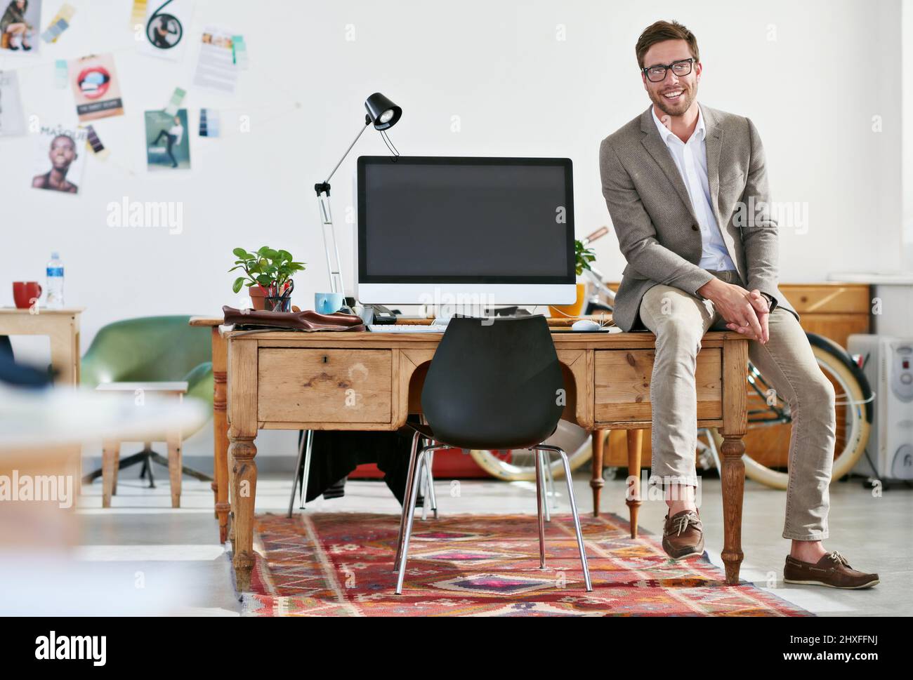 Shot of a casually-dressed young man sending a text message while at ...