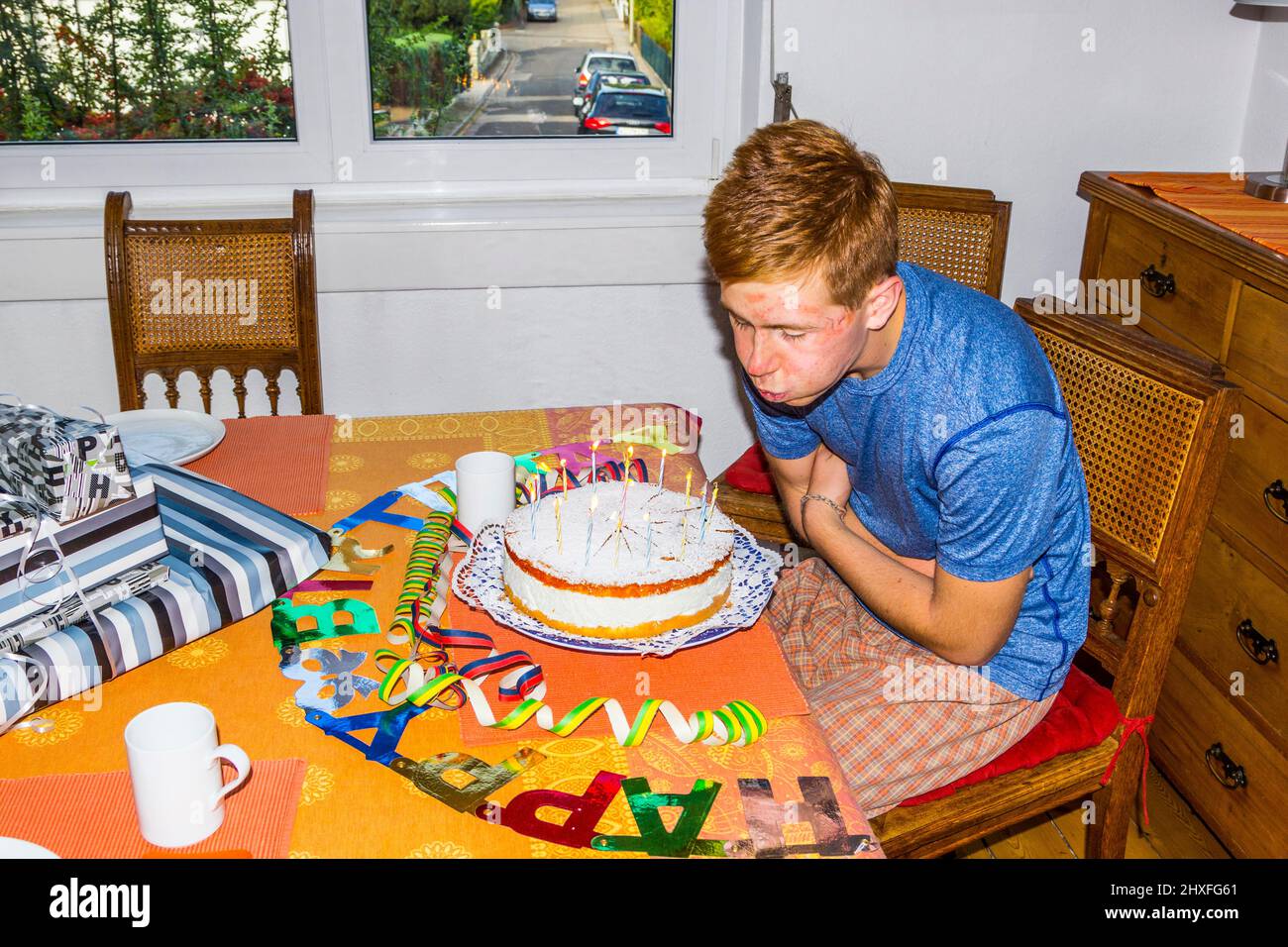 boy blowing out his birthday candles at the cake Stock Photo - Alamy