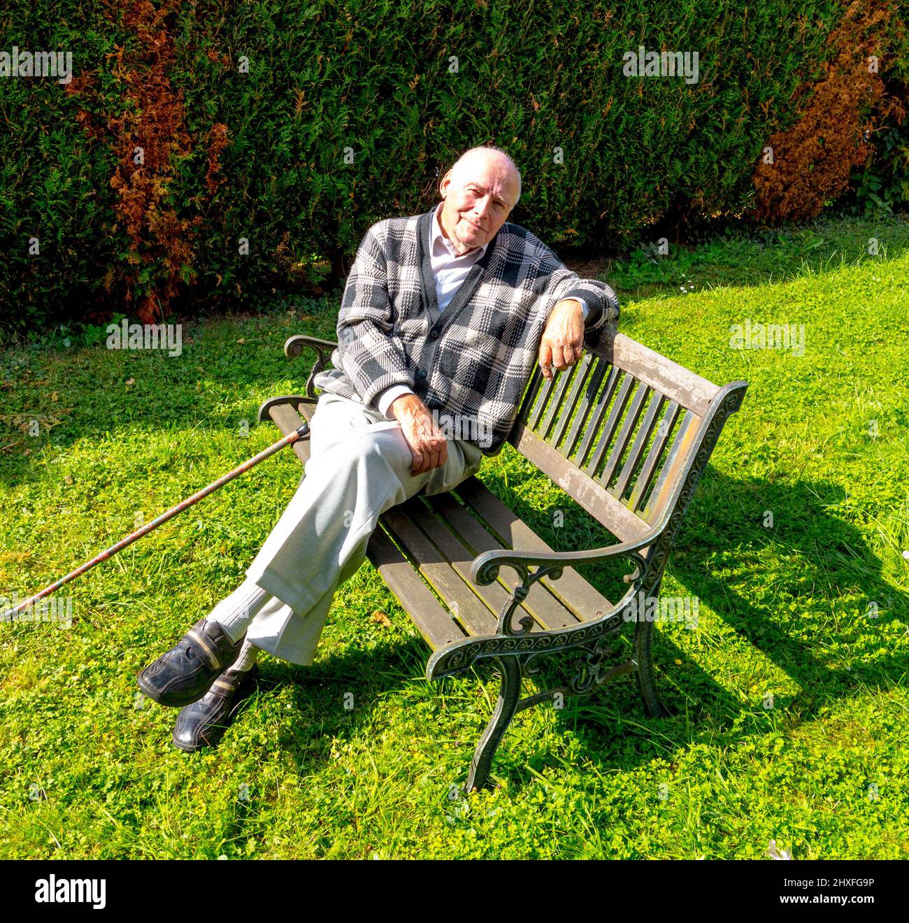 old man enjoys sitting on a bench in his garden Stock Photo - Alamy