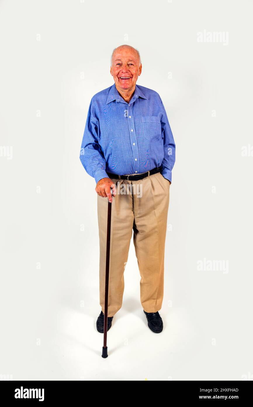 happy elderly man standing with his walking stick isolated on white ...