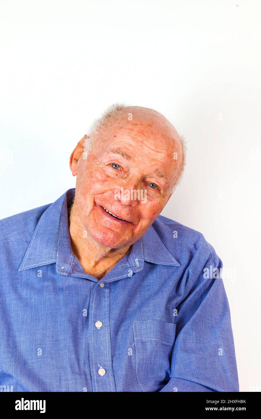 happy elderly man sitting in front of a white background Stock Photo ...