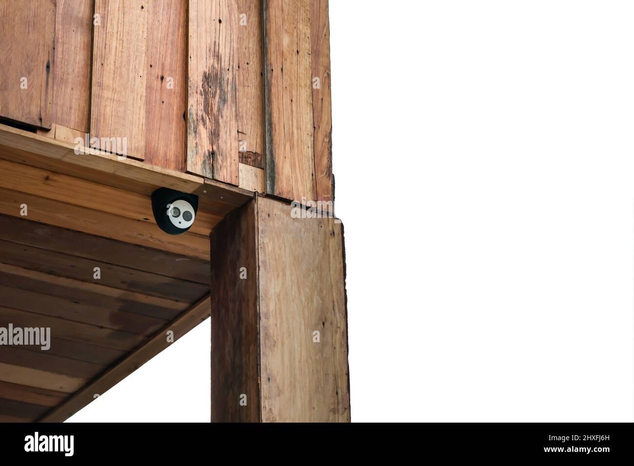 close up mini CCTV camera black case is set up on the wood ceiling ...