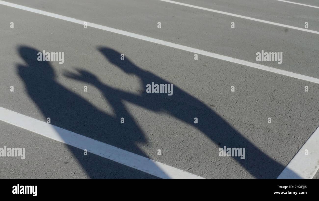 The silhouettes of two young men during angry conflict. HDR. Shadows of ...