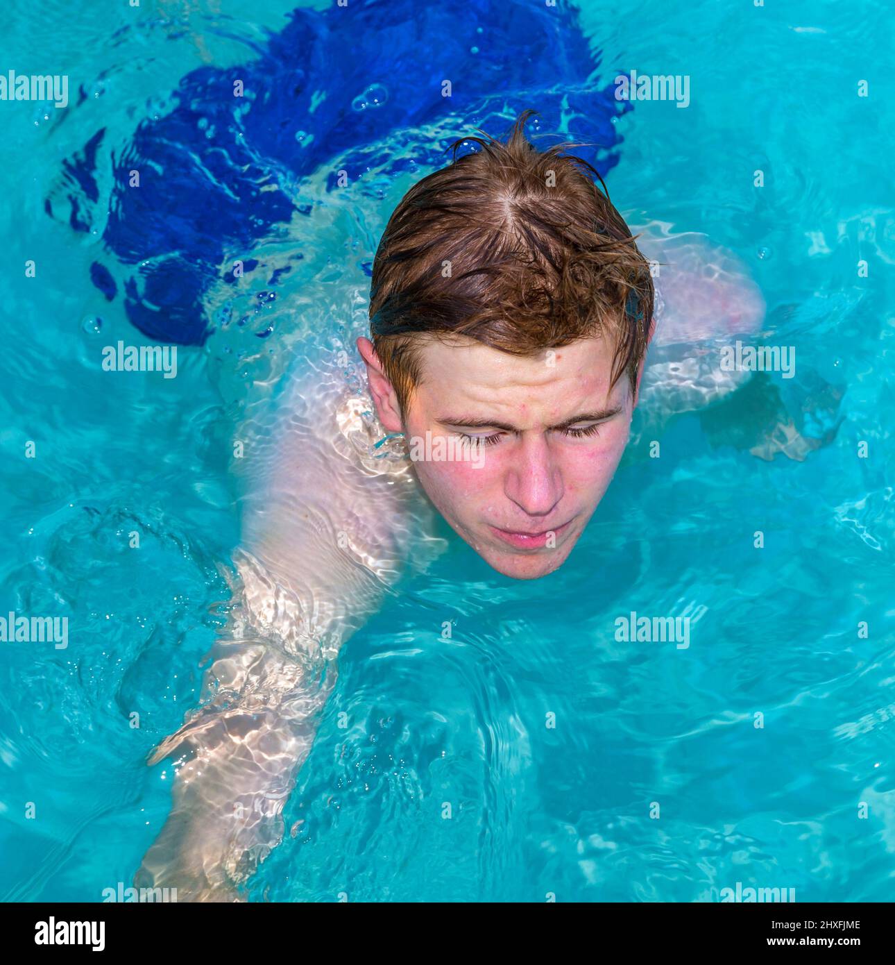 teen boy enjoys swimming in the pool Stock Photo - Alamy