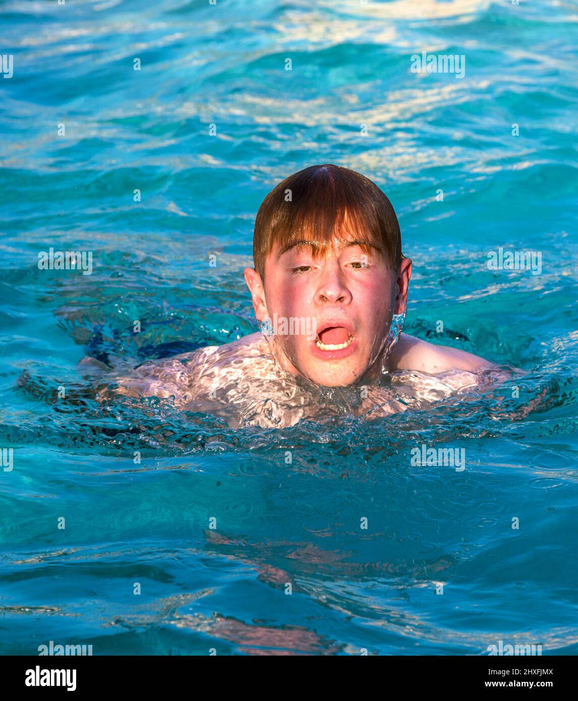 teen boy enjoys swimming in the pool Stock Photo - Alamy