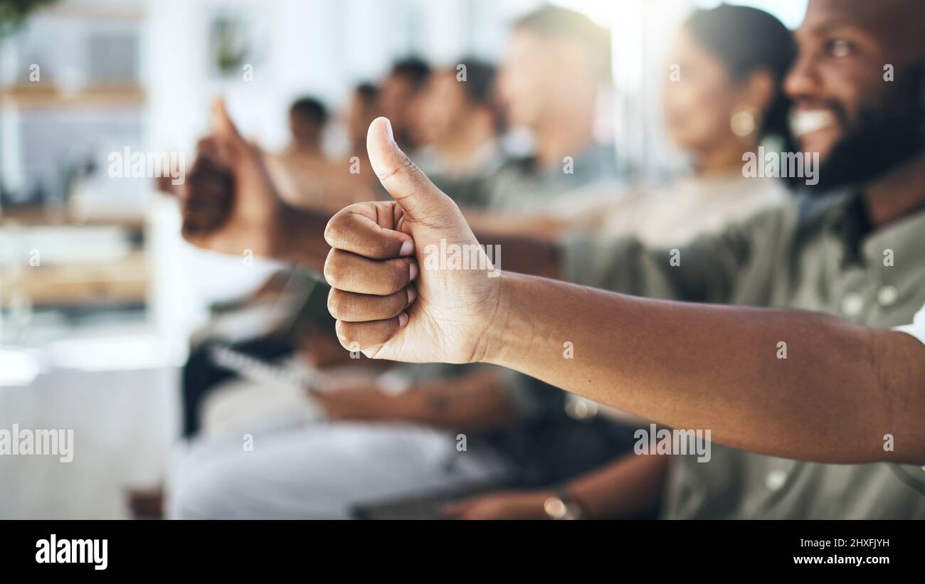 Our answer is yes. Cropped shot of a group of businesspeople giving ...