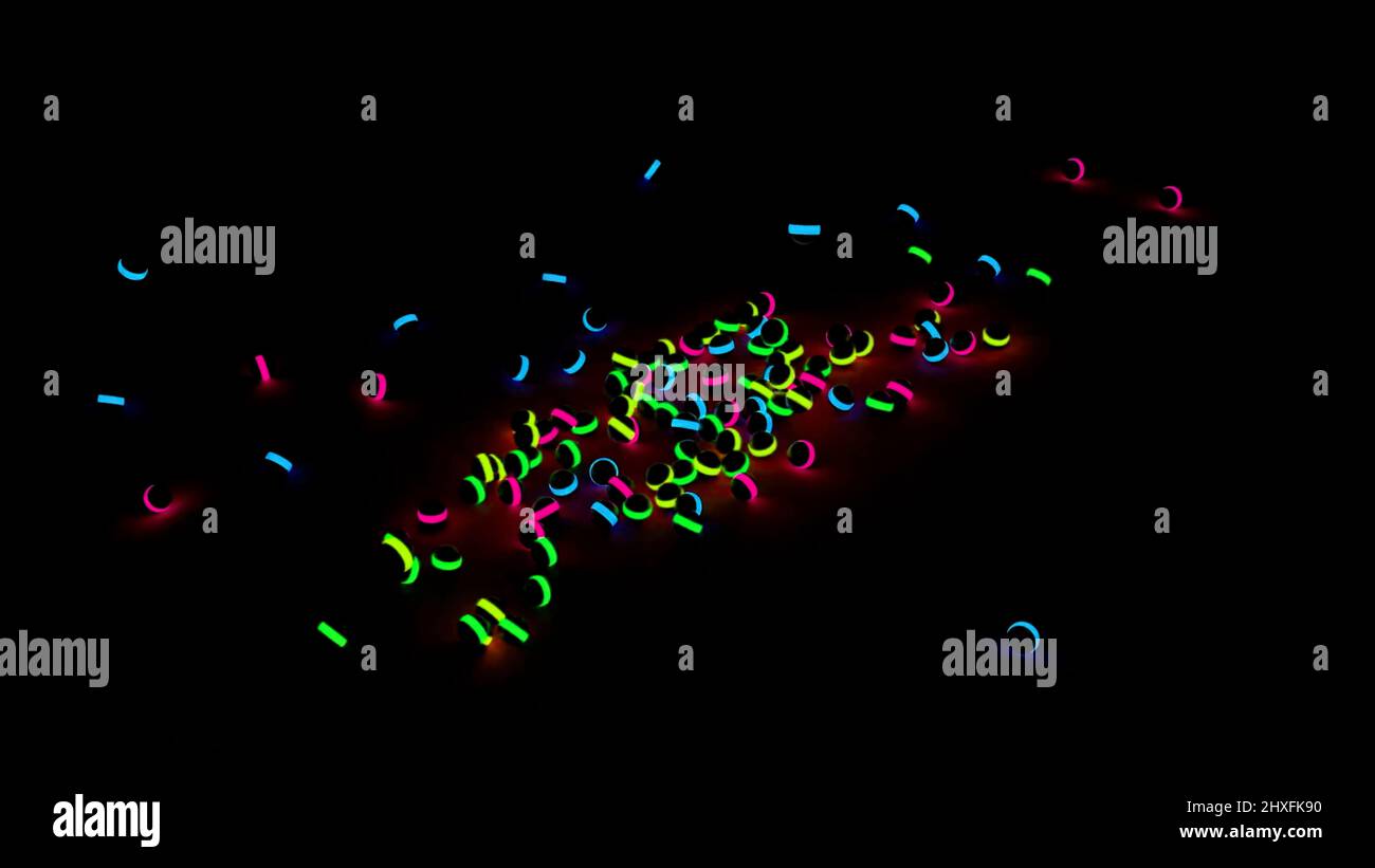 Colorful shining balls falling and rolling on a black background ...