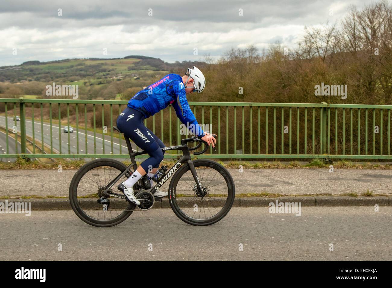 Male cyclist riding sports S-Works road bike on countryside route ...