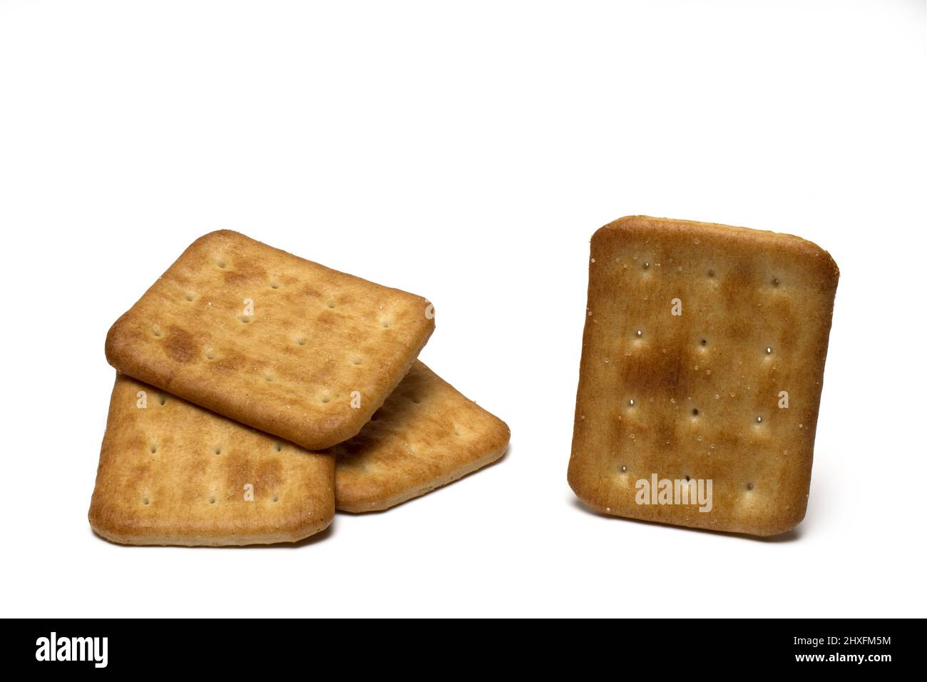 Close up golden brown crispy rectangle salt crackers on white ...