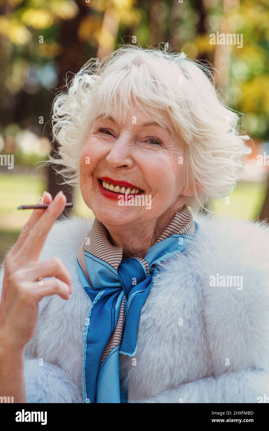 Mature woman smoking cigarette hi-res stock photography and images - Alamy