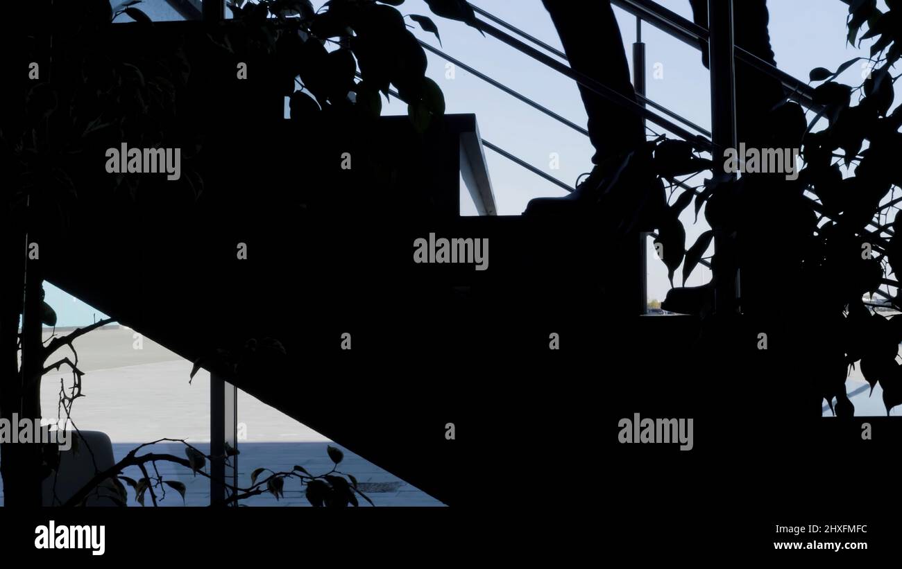 Side view of dark stairs hidden in the shadow with walking people. HDR ...