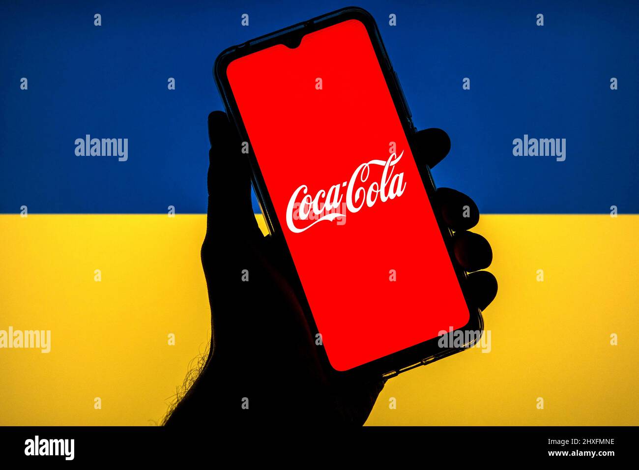 In this photo illustration a Coca-Cola logo seen displayed on a ...