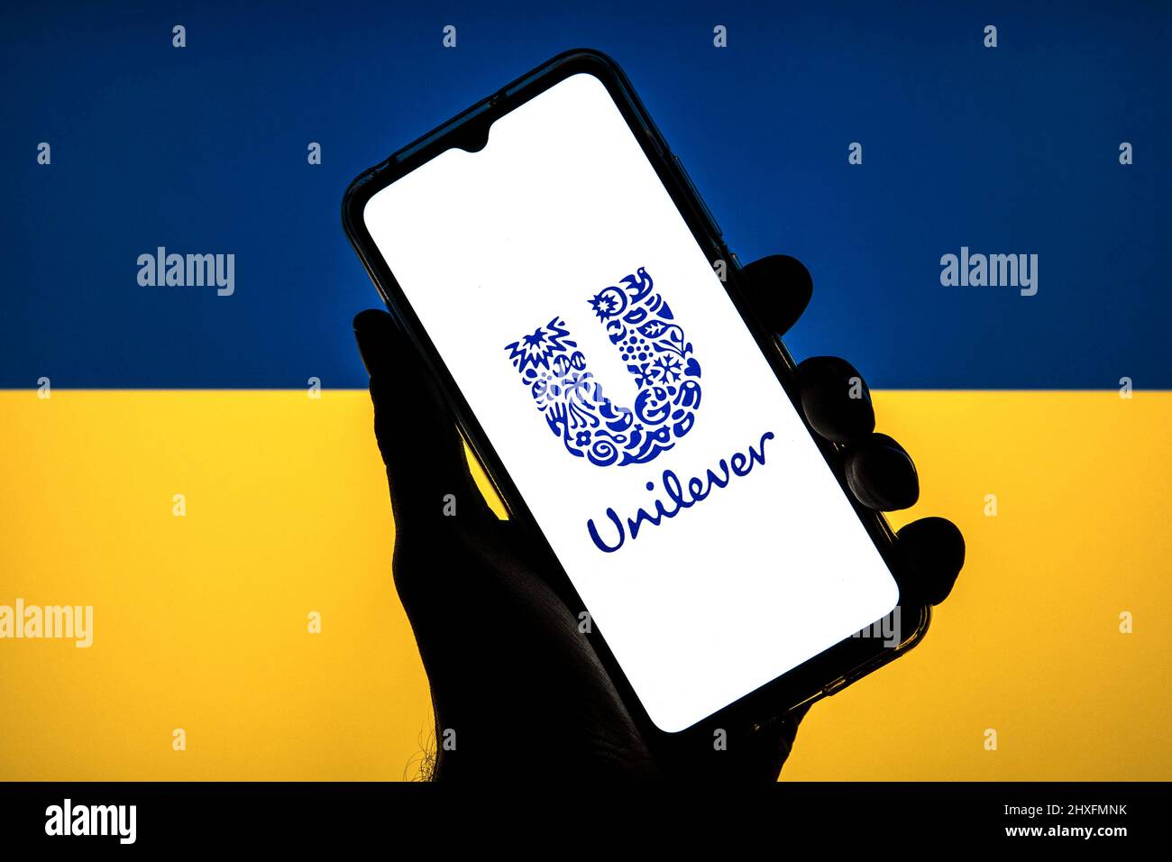 In this photo illustration a Unilever logo seen displayed on a ...