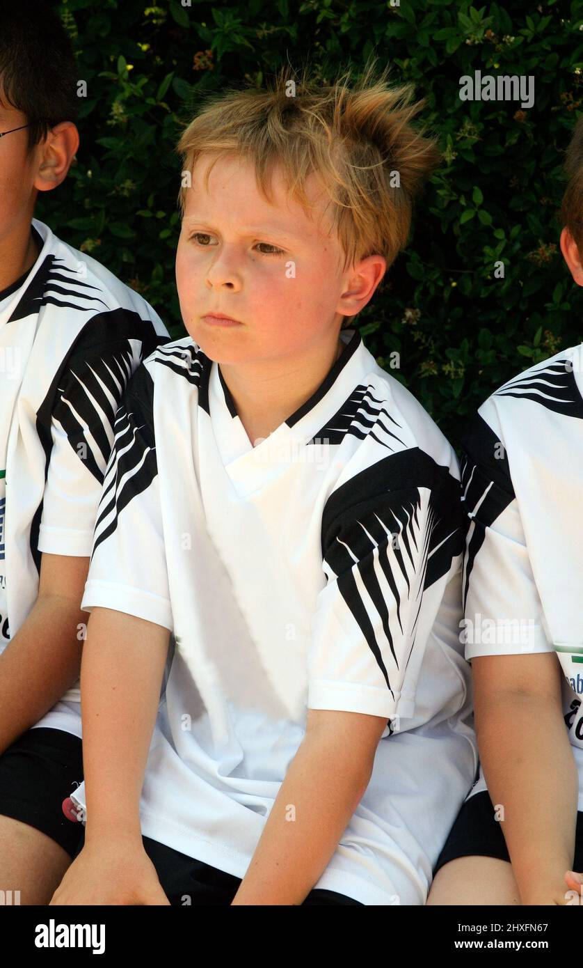 boy is looking angry and sad from soccer playing because they are not ...