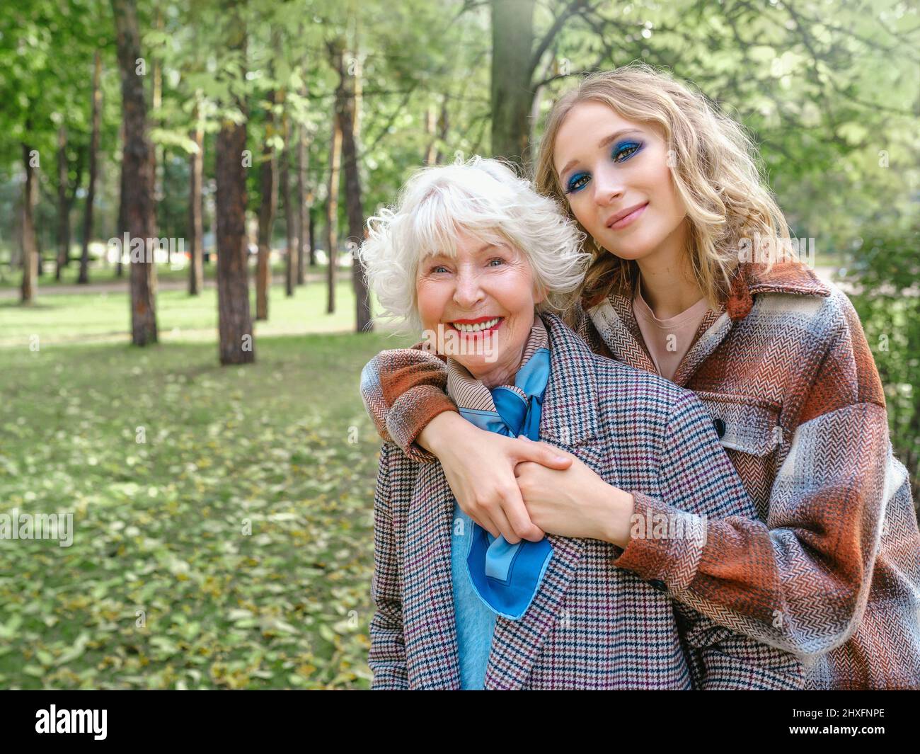 senior woman with young daughter walking outdoor in spring. Family ...