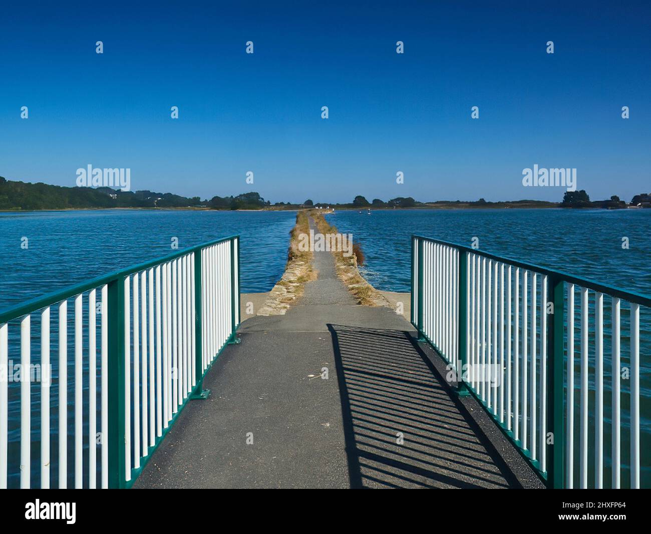 A causeway snakes between rippled water across Bembridge Harbour to ...