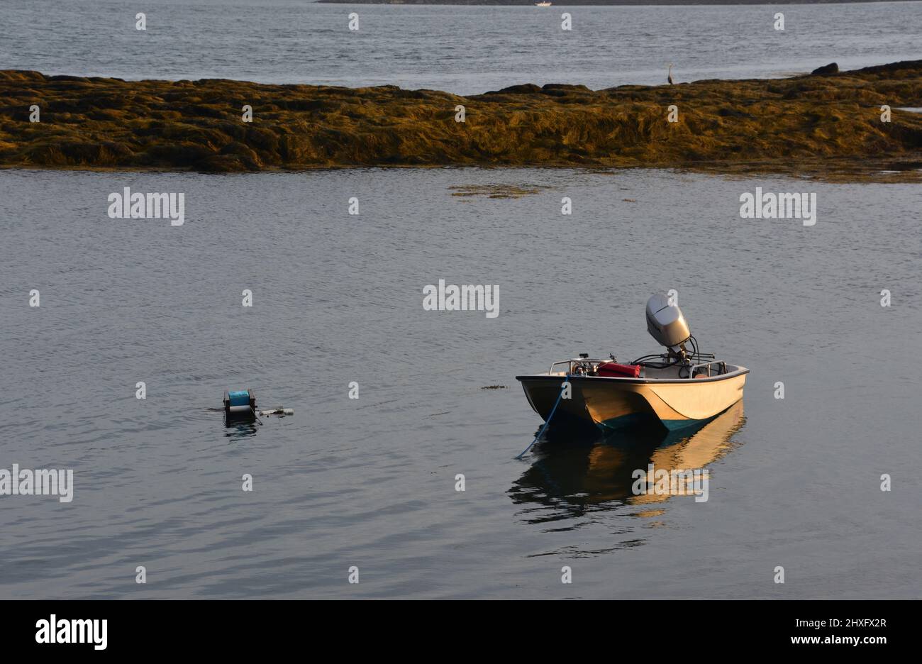 Boat with sun reflecting off the boat into the water Stock Photo - Alamy