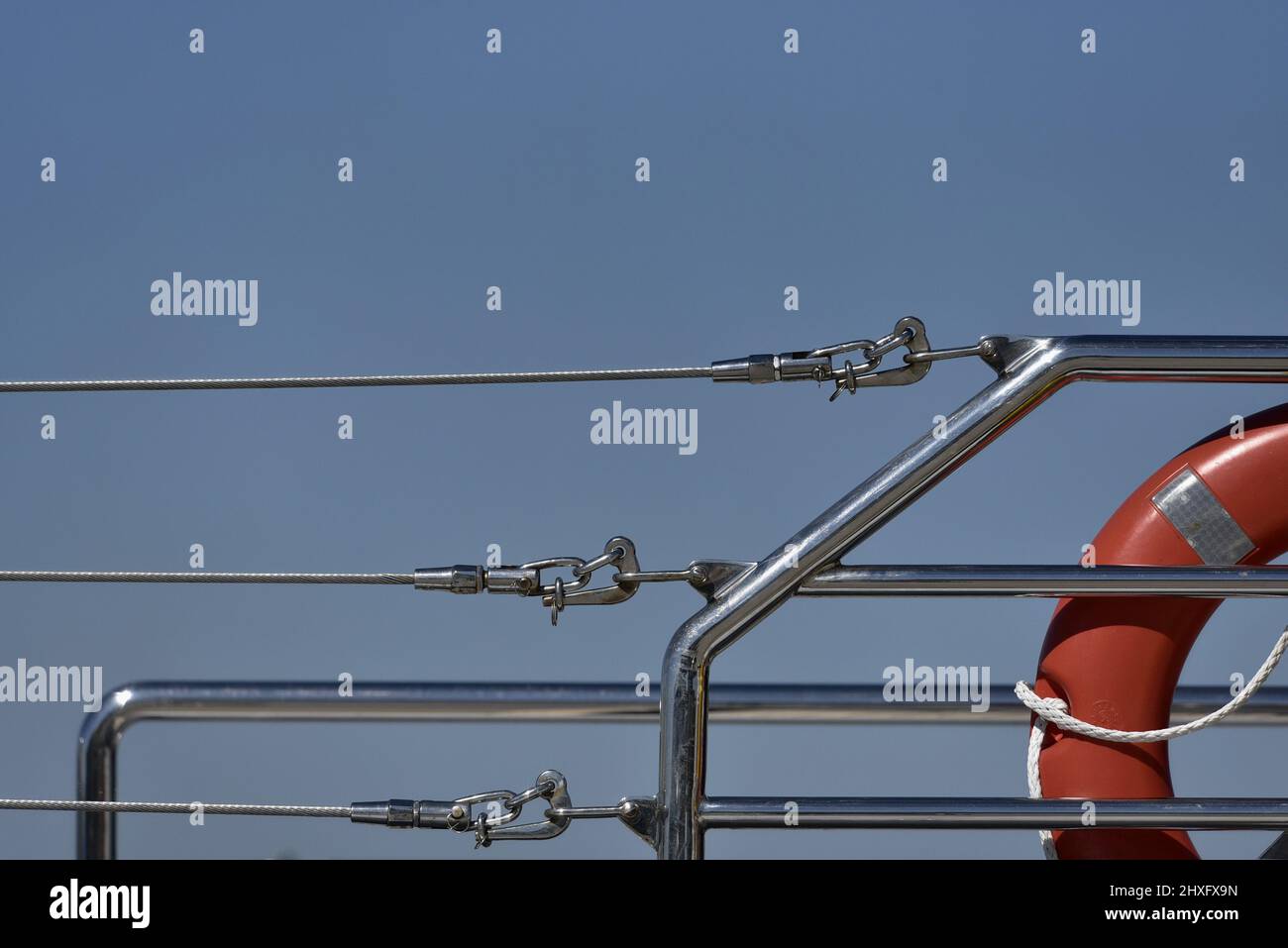 Luxury sailing boat life saver tied on the wired chrome guardrails ...