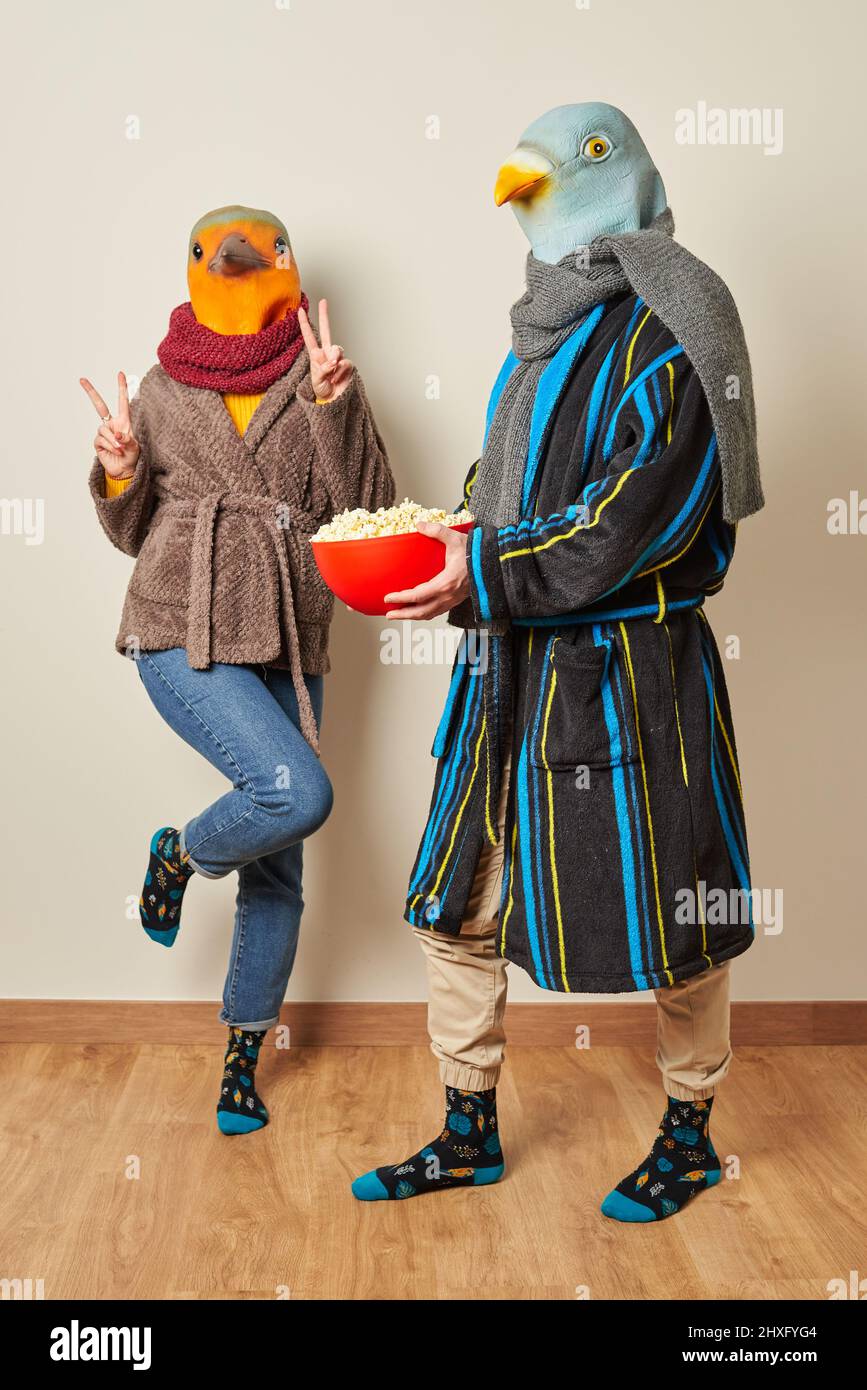 A couple dressed as birds in dressing gowns with popcorn Stock Photo ...