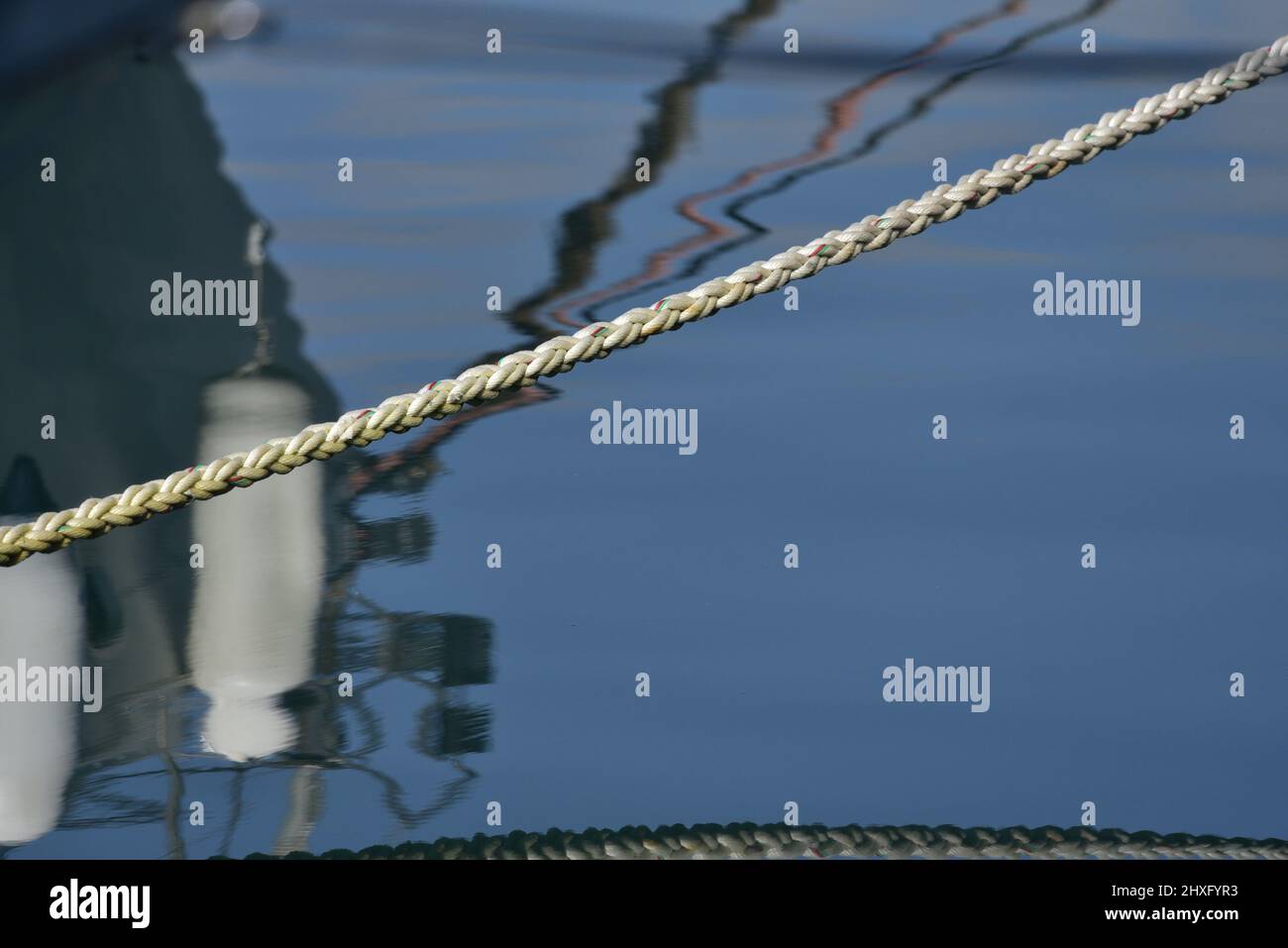 Nylon double braided mooring rope against the blue sea Stock Photo - Alamy