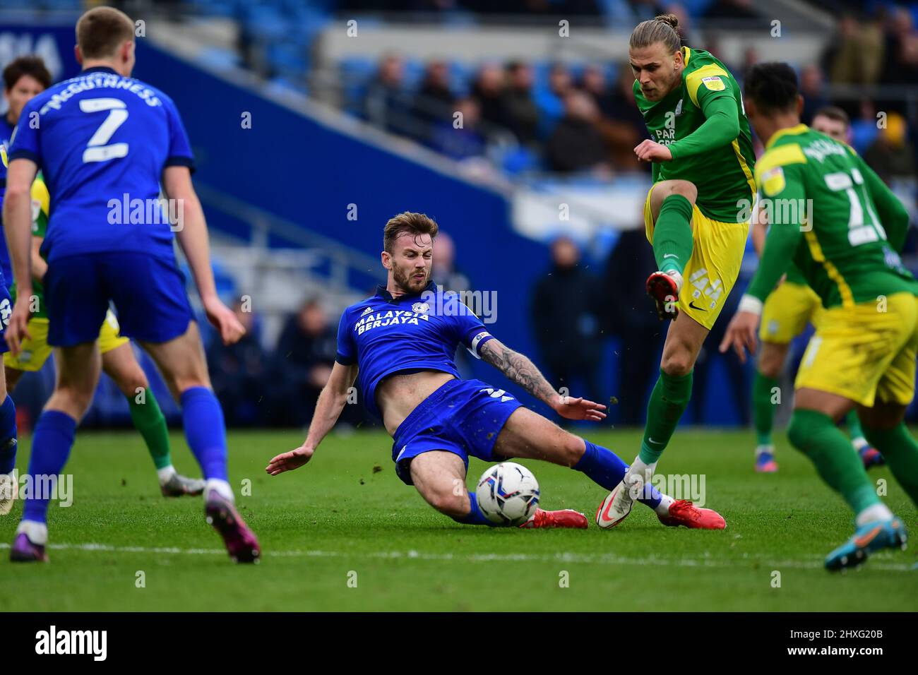 Brad Potts #44 of Preston North End shoots at goal, with tackle coming ...