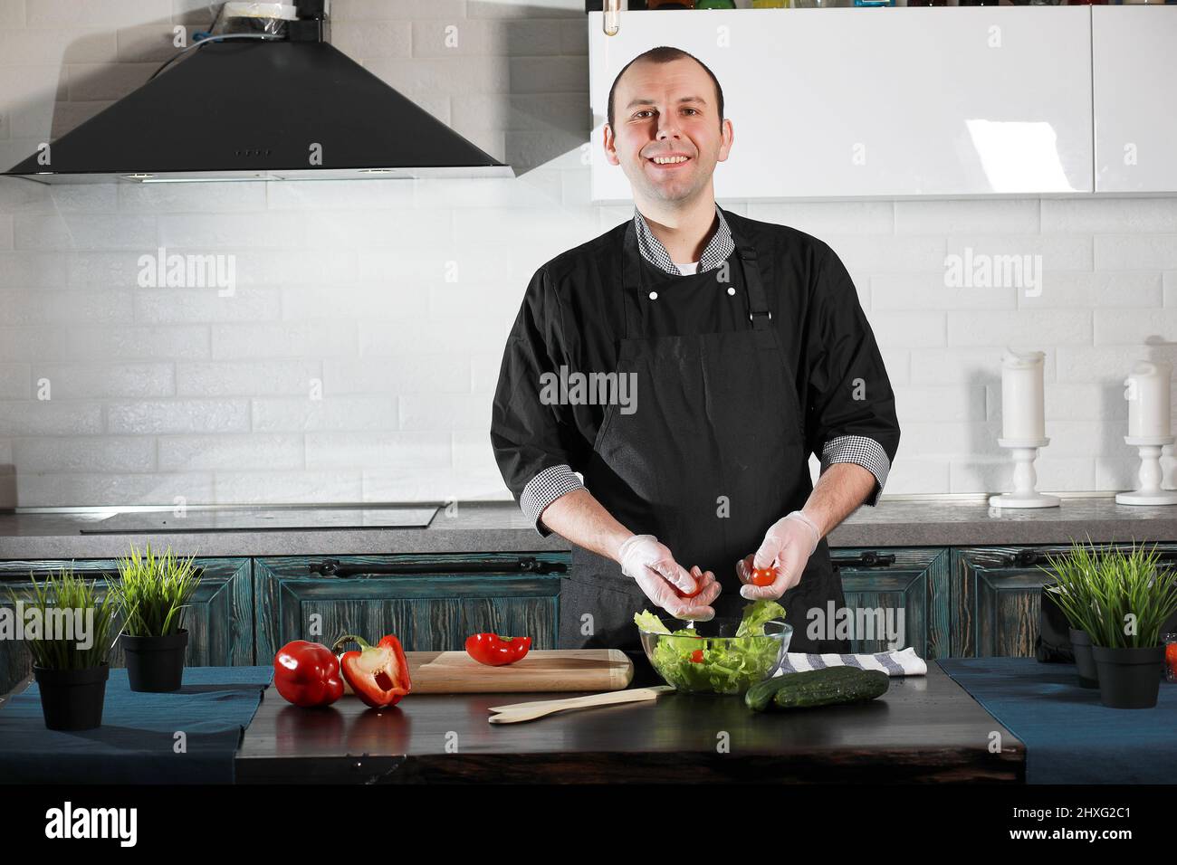 Man cook preparing food at the kitchen table of vegetables Stock Photo ...