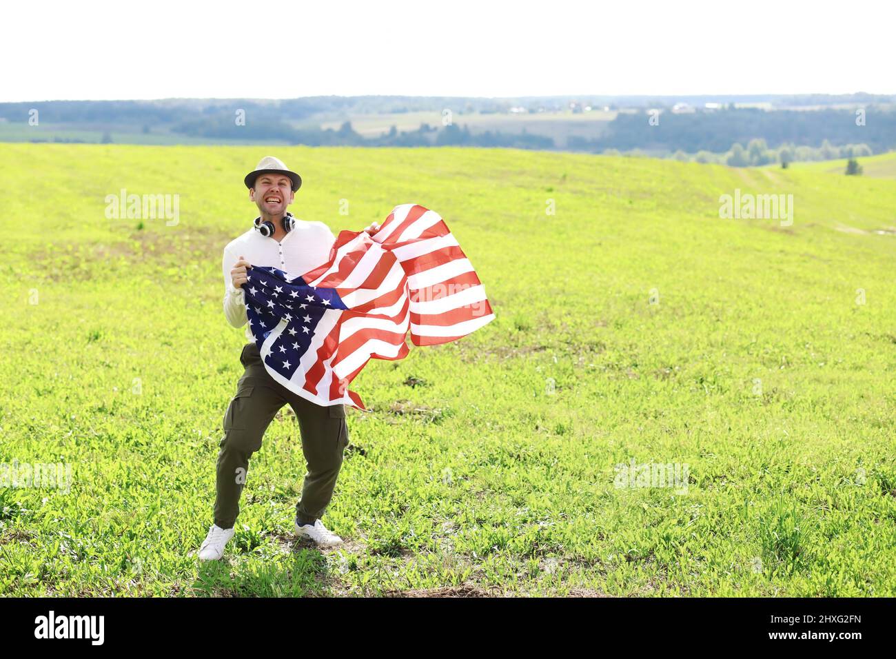 Man waving American flag standing in farm agricultural field , holidays ...
