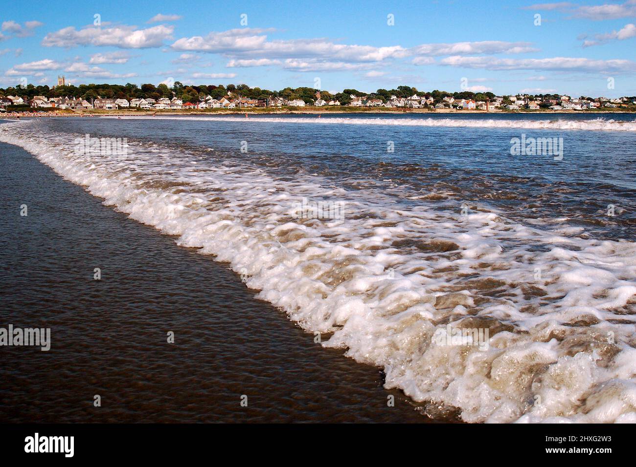A long line of waves crash into the shore Stock Photo - Alamy