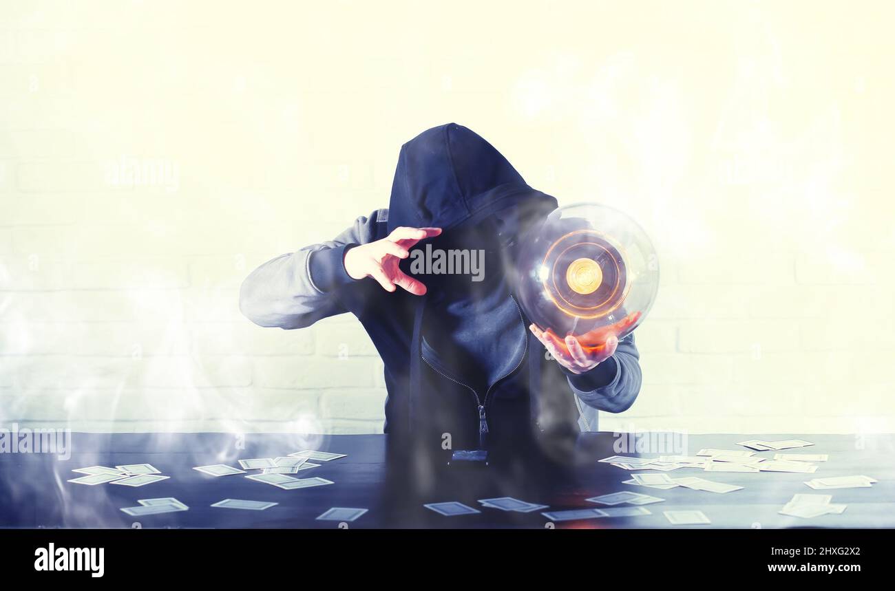 A man with a fortune teller ball at the table Stock Photo - Alamy