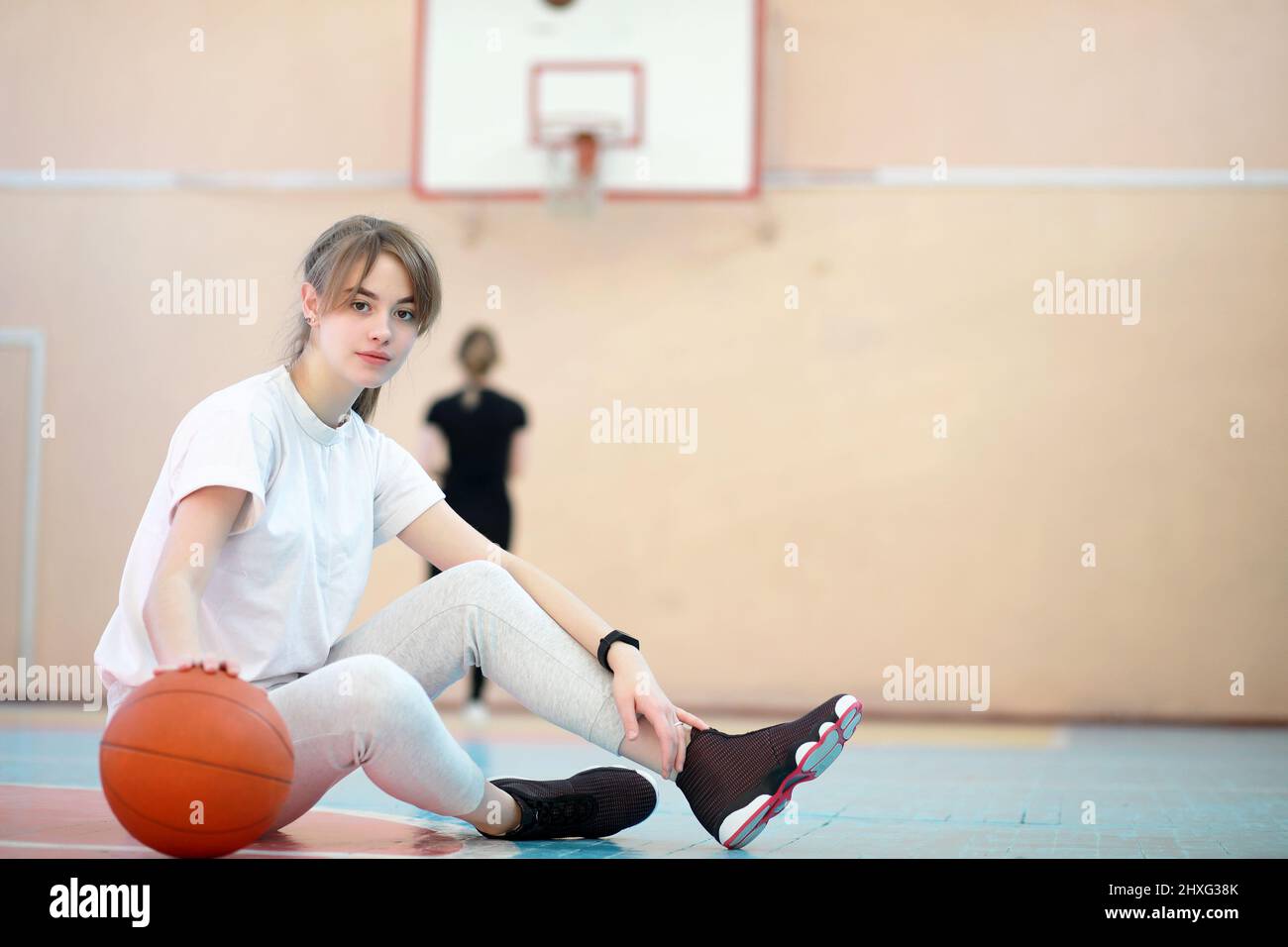 Girl young student in the gym playing a basketball Stock Photo - Alamy