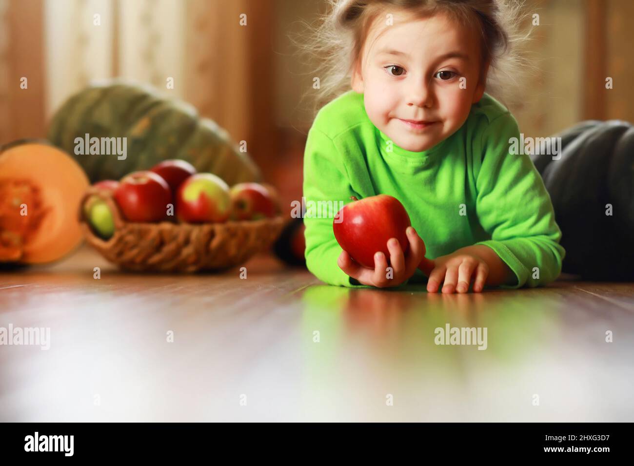 Little child choose a pumpkin autumn. Child sitting on giant pumpkin ...