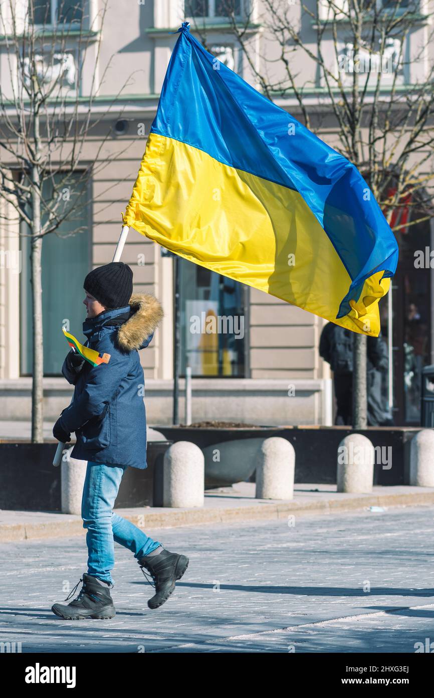 Child or kid with winter clothes, Ukrainian flag and hat. Protest ...