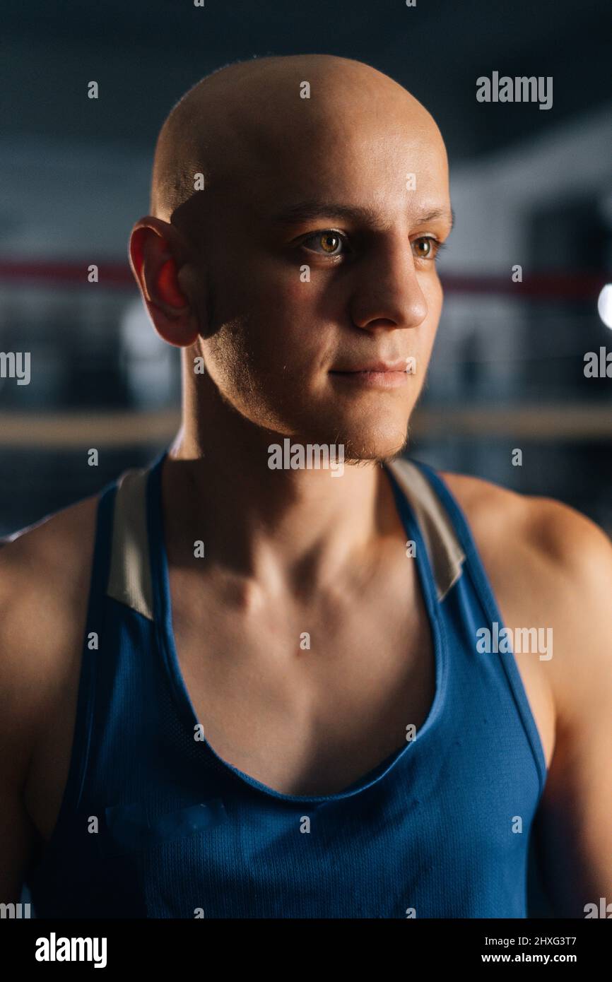 Close-up vertical shot of professional bald brutal boxer wearing ...