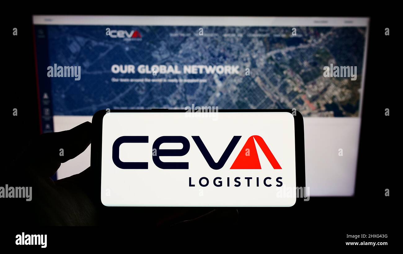 Person holding mobile phone with logo of French freight company CEVA ...