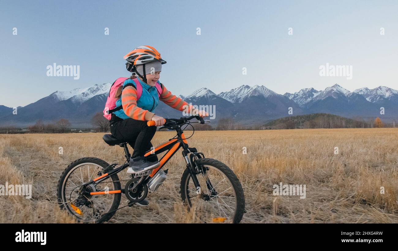 One caucasian children rides bike in wheat field. Little girl riding ...