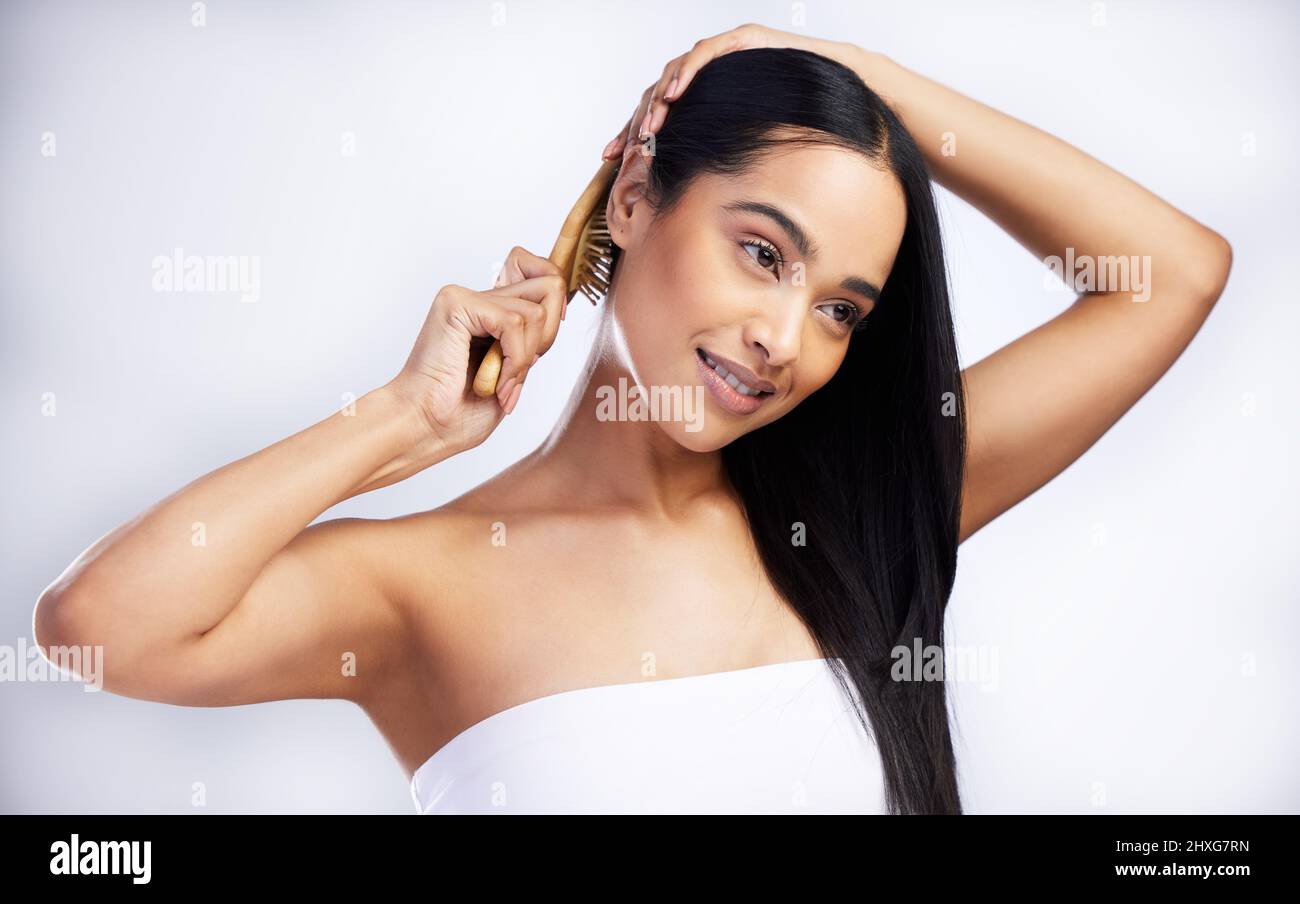 I make it a habit to brush my hair regularly. Shot of an attractive ...