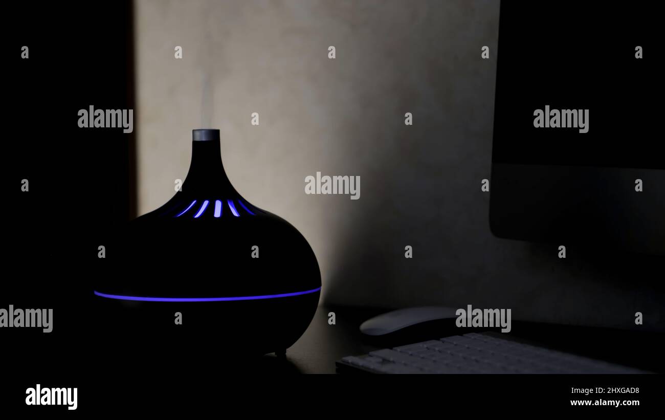 Aromatherapy oil diffuser with colorful LED light from which steam ...